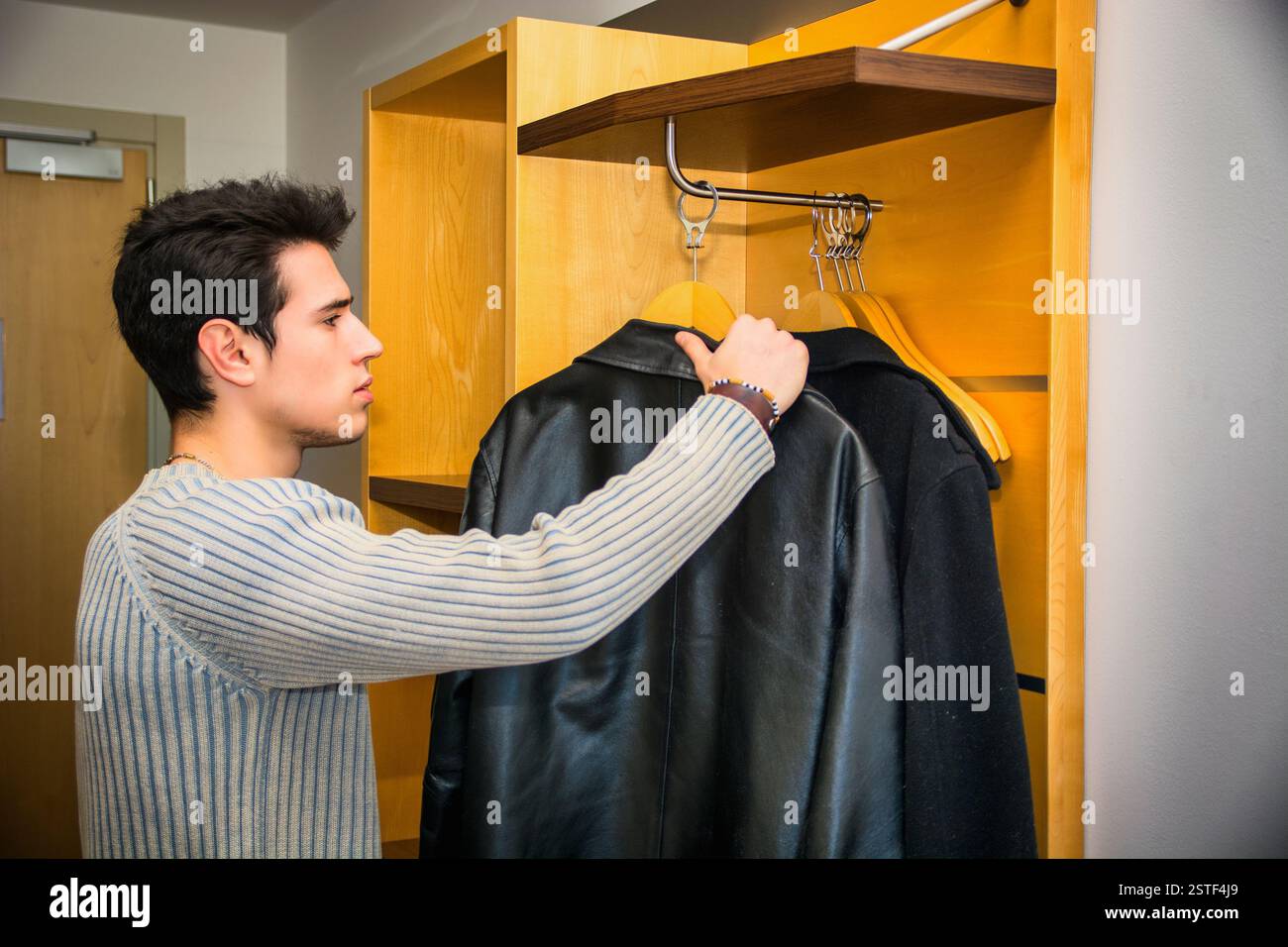 Handsome Man Hanging his Coats Inside his Wardrobe Stock Photo - Alamy