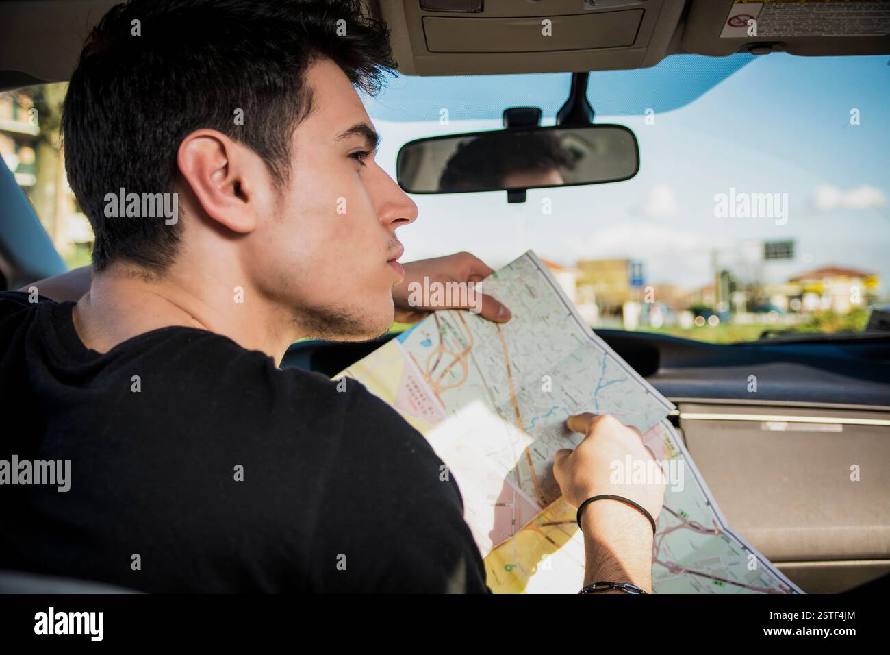 Gorgeous Young Man Inside Car Asking for Directions Holding a Map Stock ...