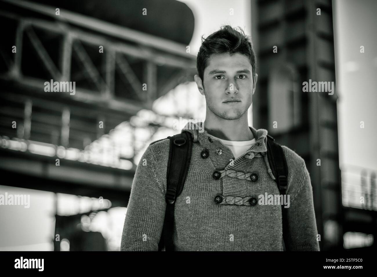 Handsome young man in city setting, lit by sunset light Stock Photo - Alamy