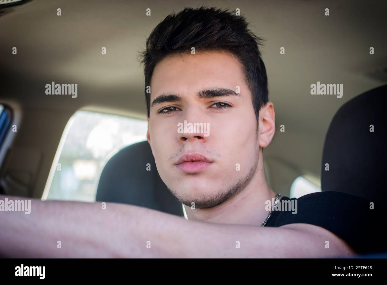 Serious young man or teenager driving car Stock Photo - Alamy