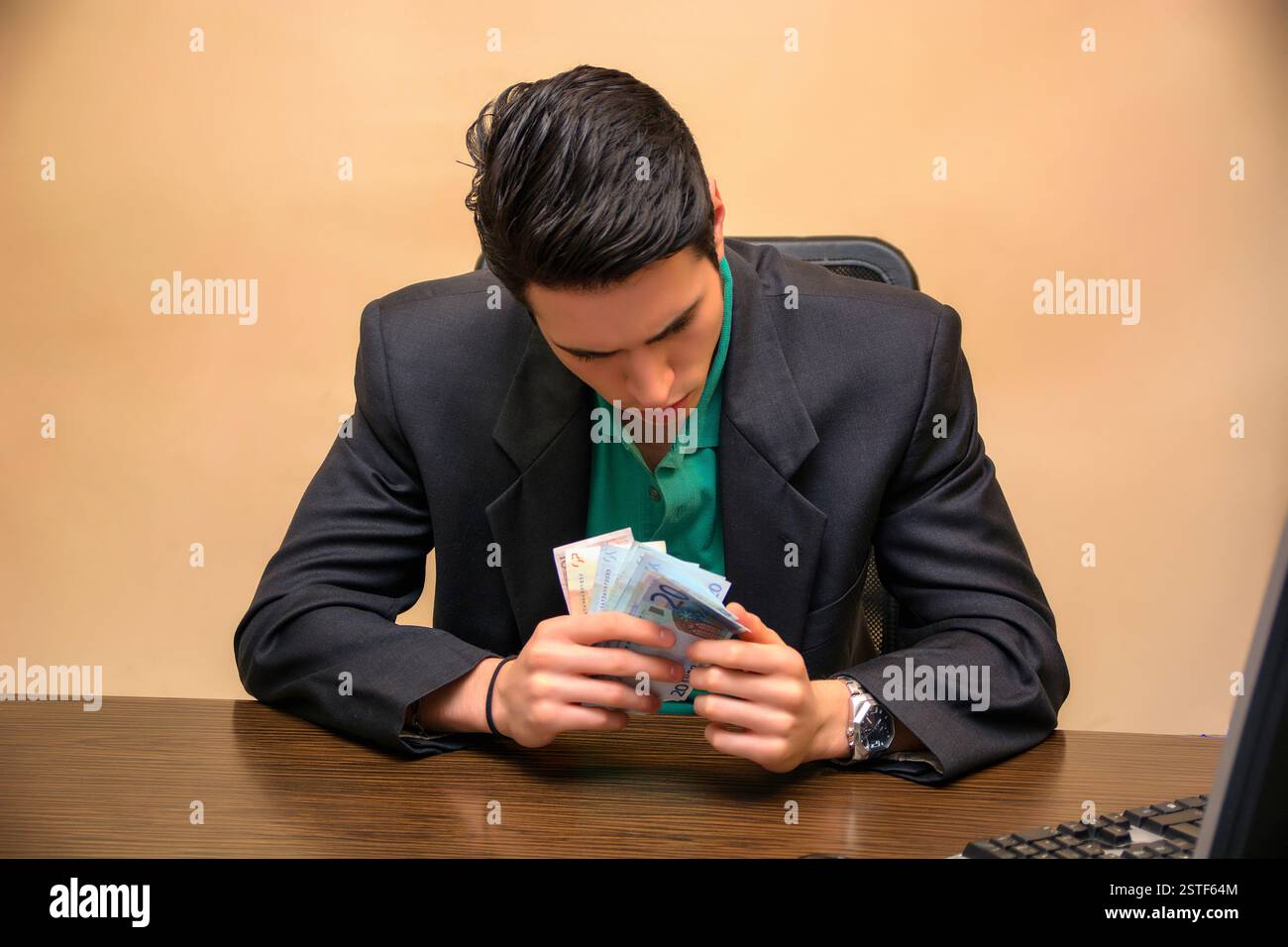 Sitting Young Businessman Counting Cash on Hand Stock Photo - Alamy