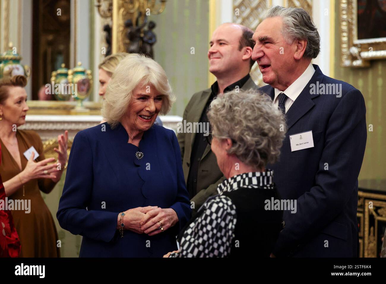 Queen Camilla speaks with actors Imelda Staunton and Jim Carter as she ...
