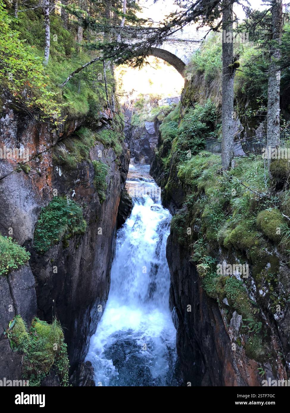 A stunning gorge filled with rushing water flows through rocky ...