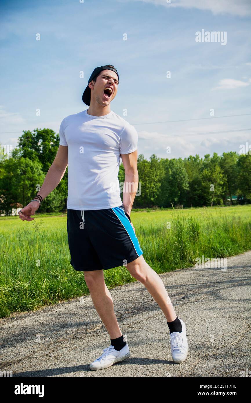 Handsome young man injured while running and jogging on road in the ...