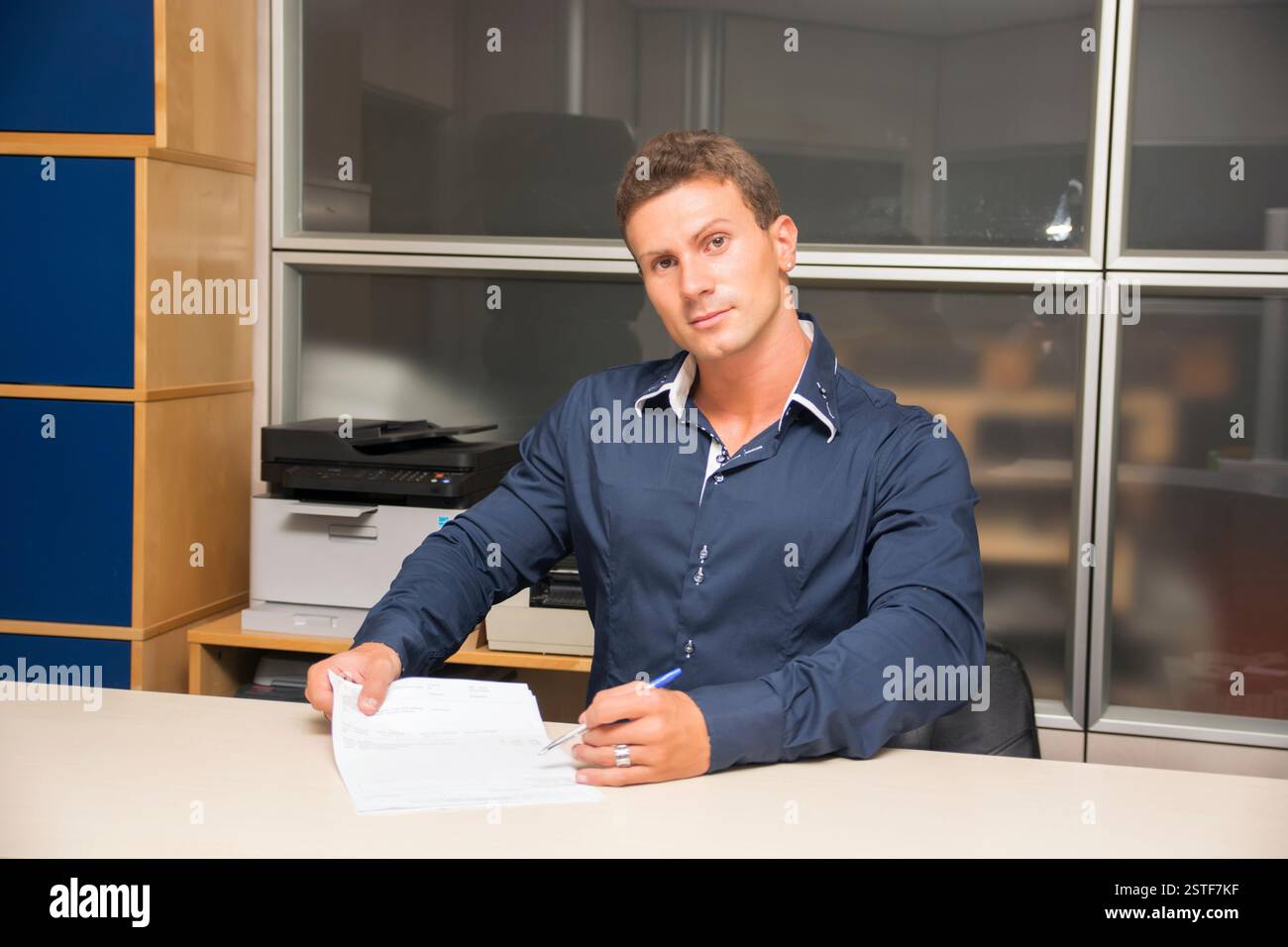 Writing on a document and asking for signature hi-res stock photography ...