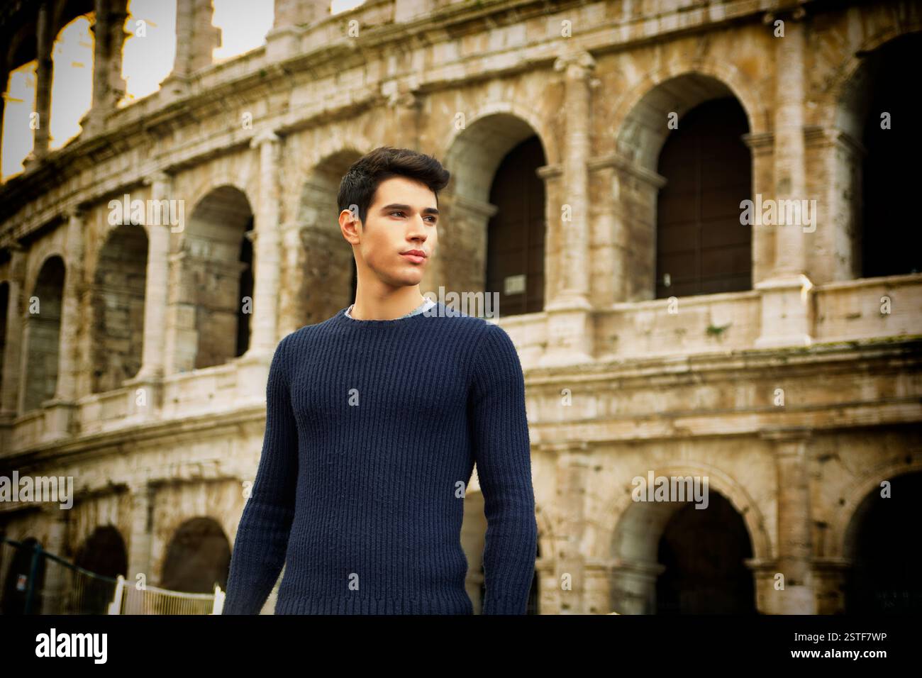 Attractive young man in Rome standing in front of the Colosseum Stock ...