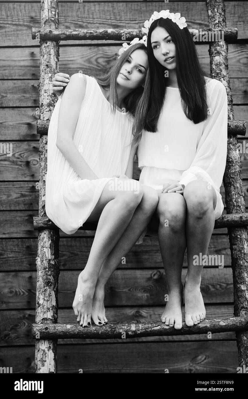 Two girls on one Black and White Stock Photos & Images - Alamy