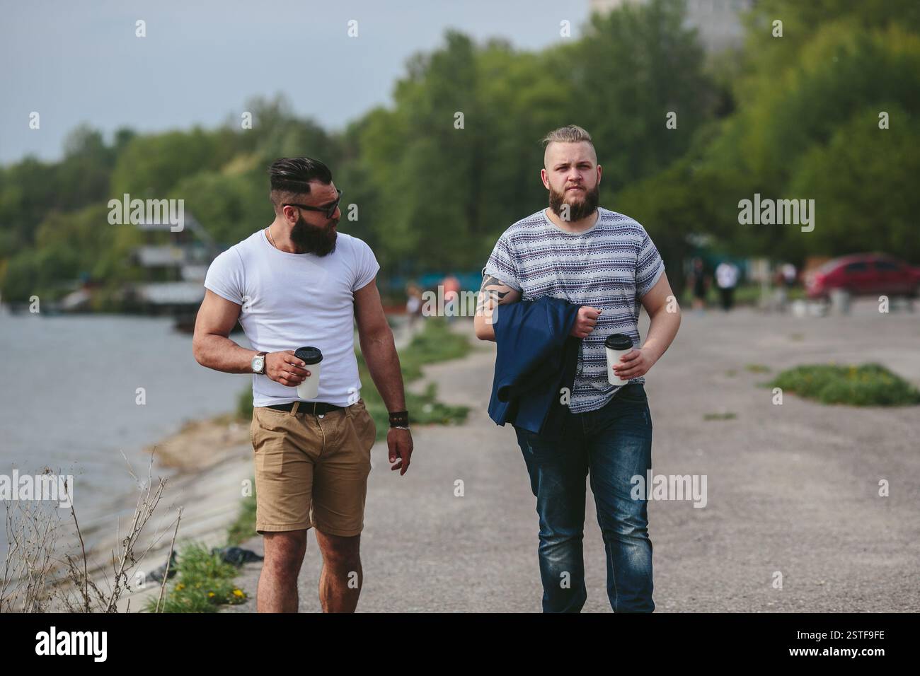 Three men walk hi-res stock photography and images - Alamy