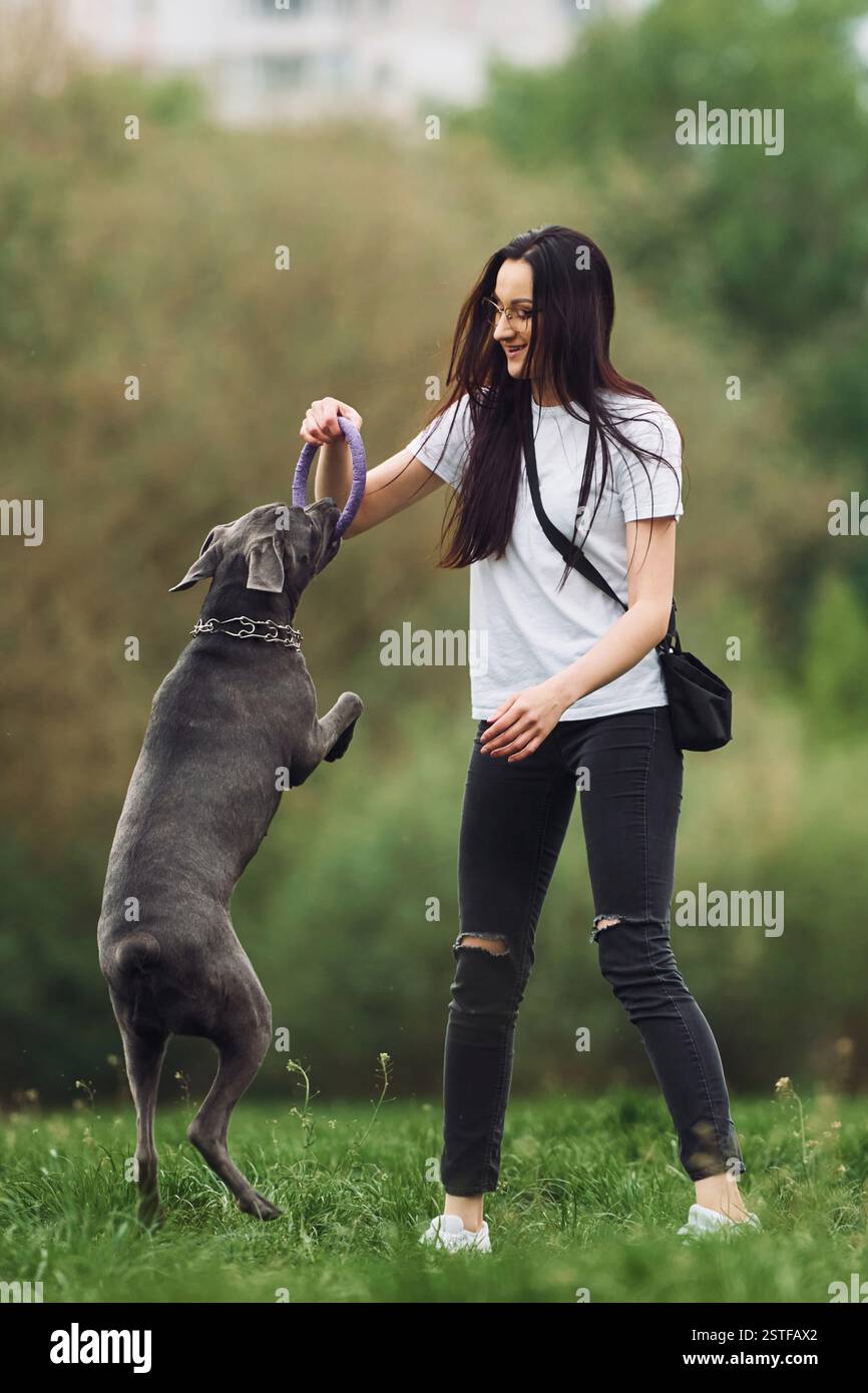 Active weekend time spending. Young brunette is having a walk with her ...