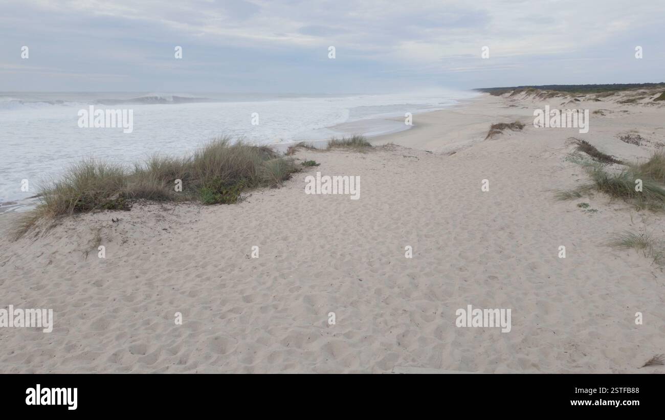 Expansive sandy dunes at Furadouro Beach, Portugal, where strong ...