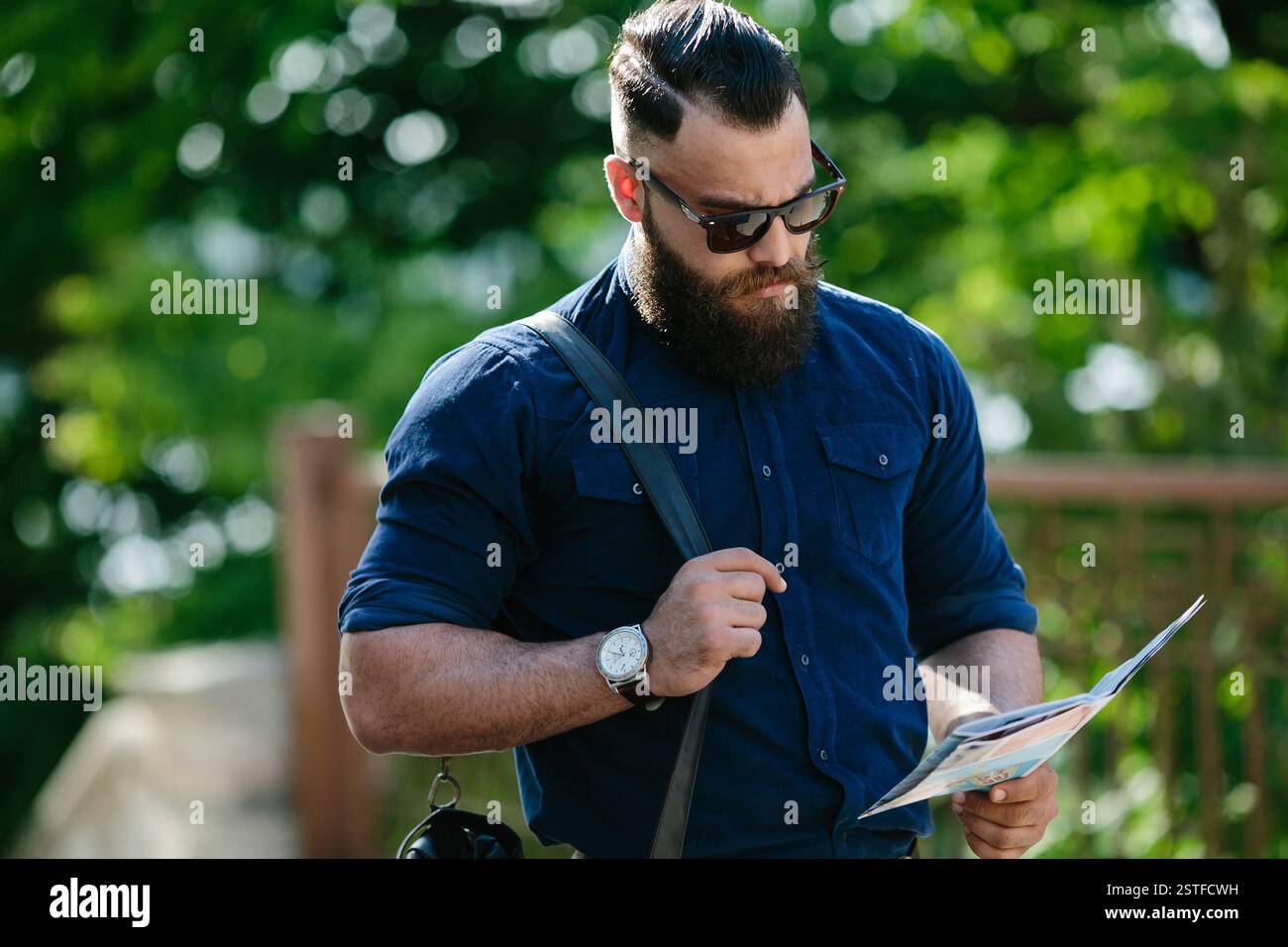 Bearded man looking at a map Stock Photo - Alamy