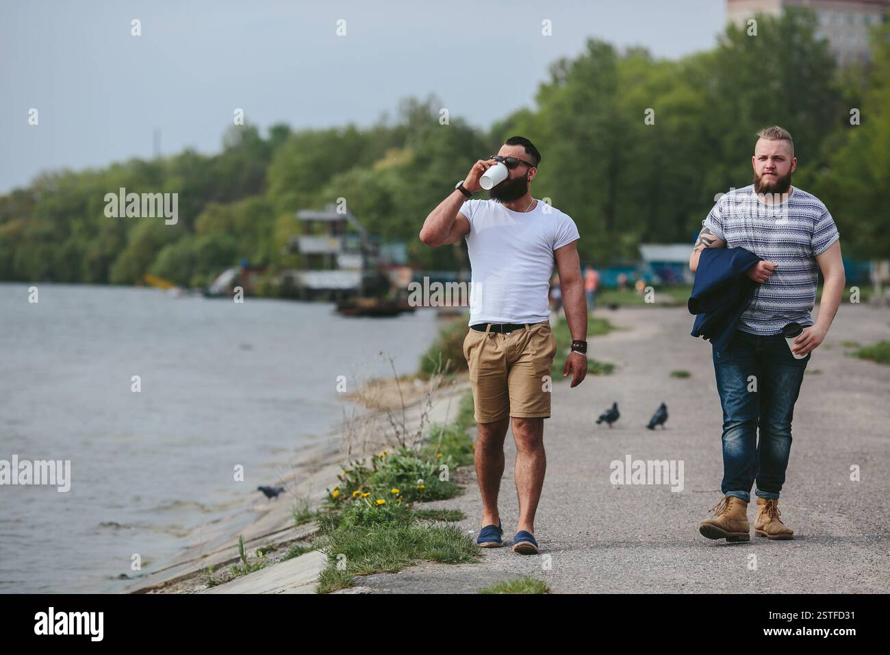 Two men walk drink coffee hi-res stock photography and images - Alamy