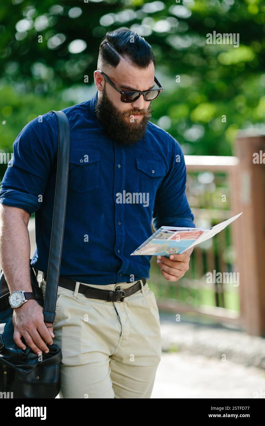 Bearded man looking at a map Stock Photo - Alamy