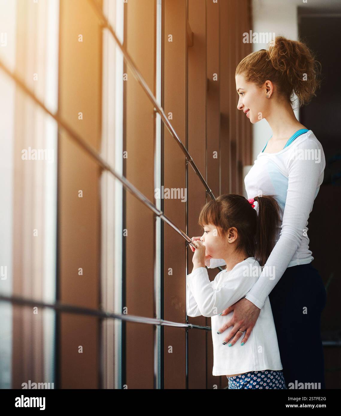 Two girls stare in window Stock Photo - Alamy