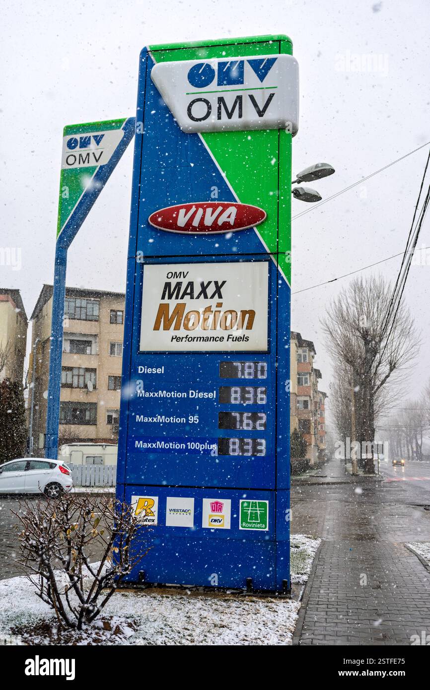 Exterior of an OMV gas station. Gasoline pumps and cars refueling in a ...