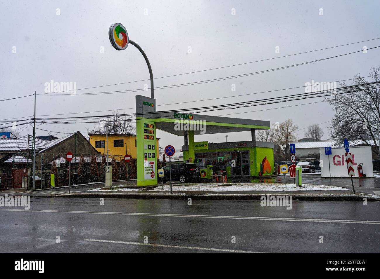 Exterior of an OCTANO gas station. Gasoline pumps and cars refueling in ...