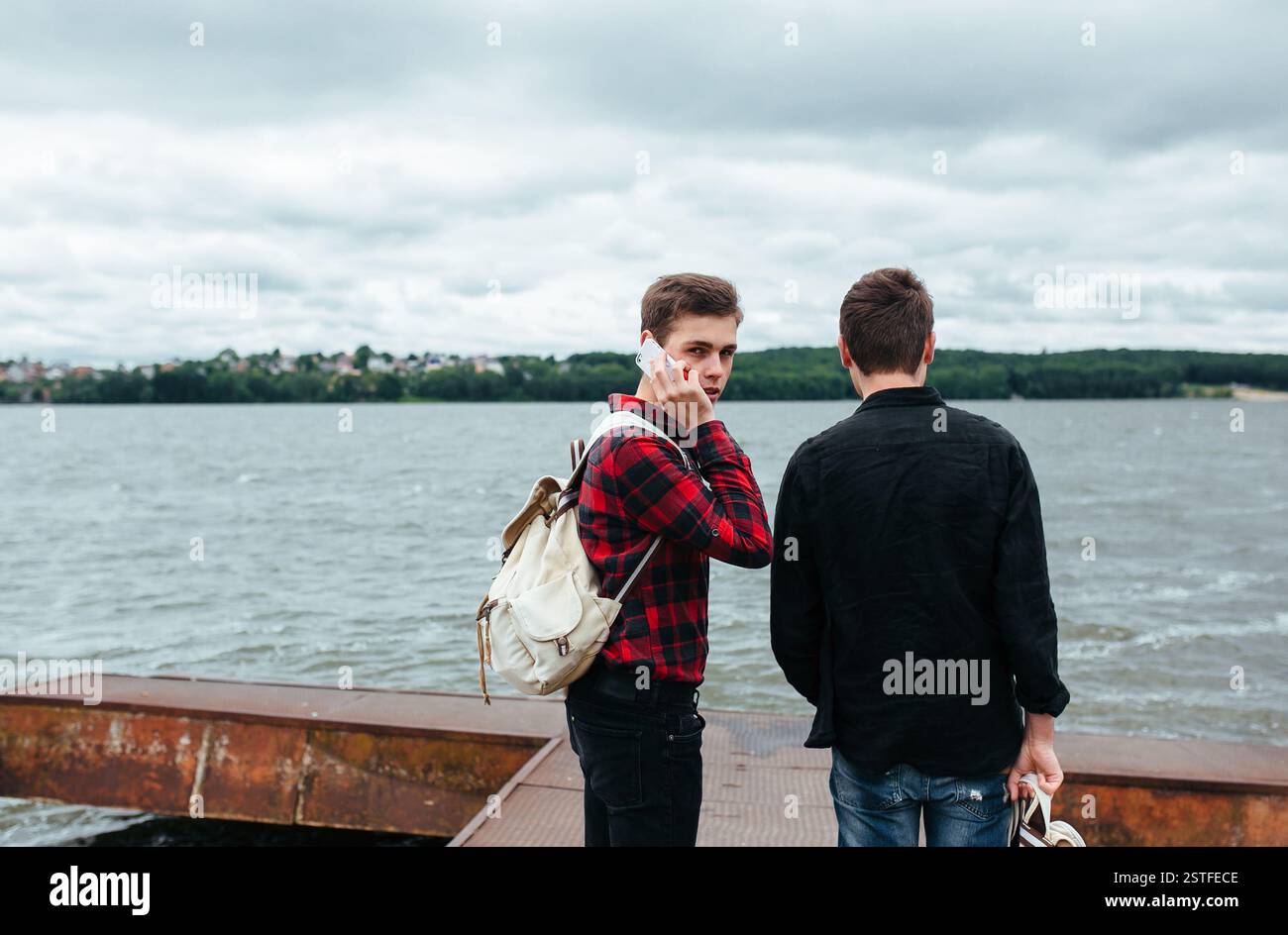 Two young men stand hi-res stock photography and images - Alamy