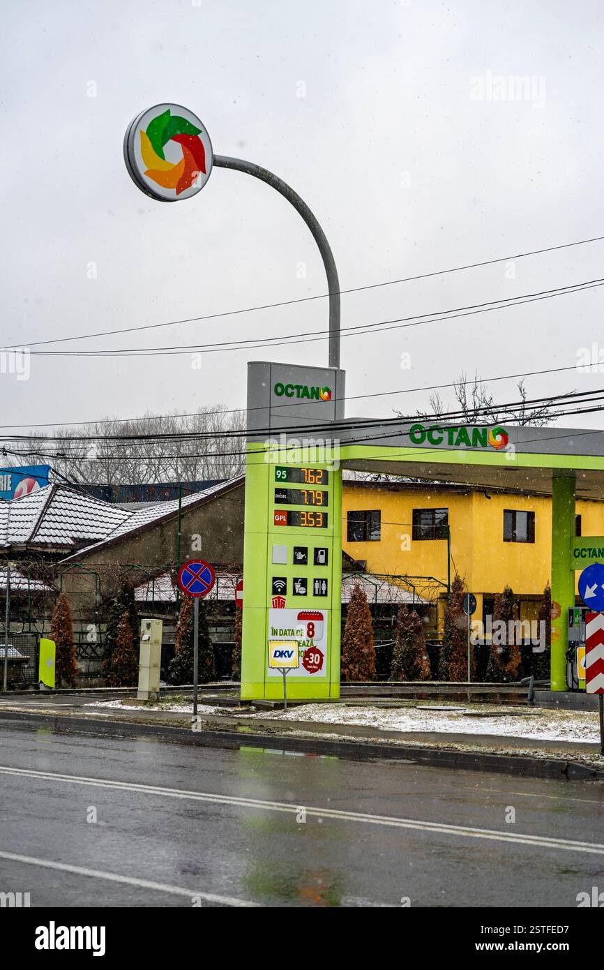 Exterior of an OCTANO gas station. Gasoline pumps and cars refueling in ...