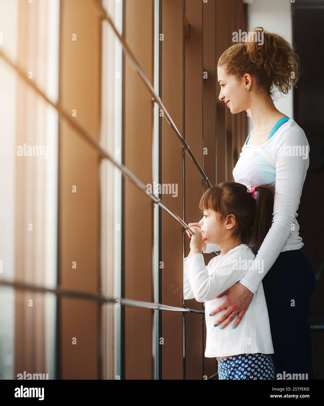 Two girls stare in window Stock Photo - Alamy