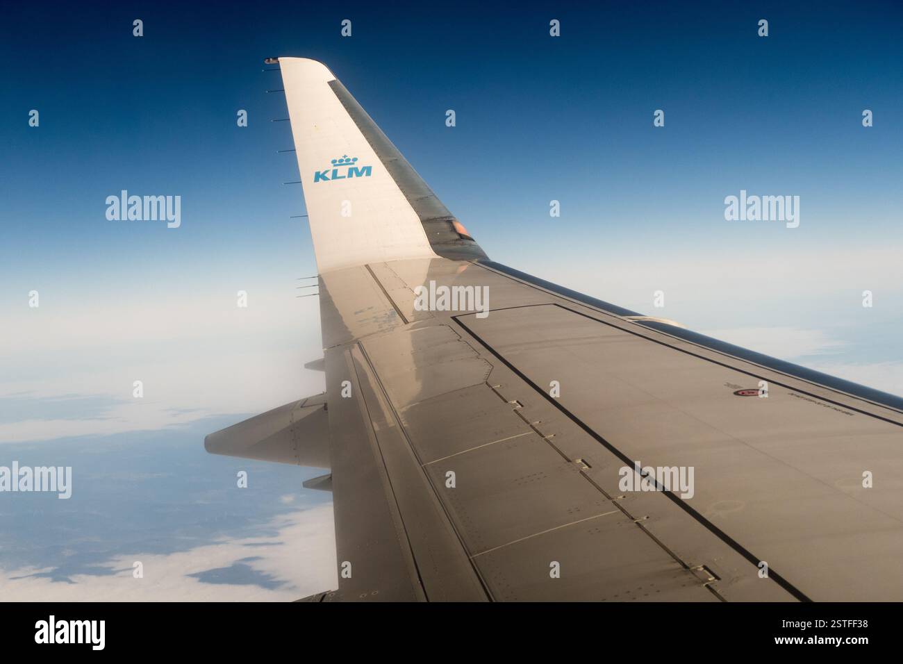 A KLM aircraft wing seen from the passenger window, soaring through the ...