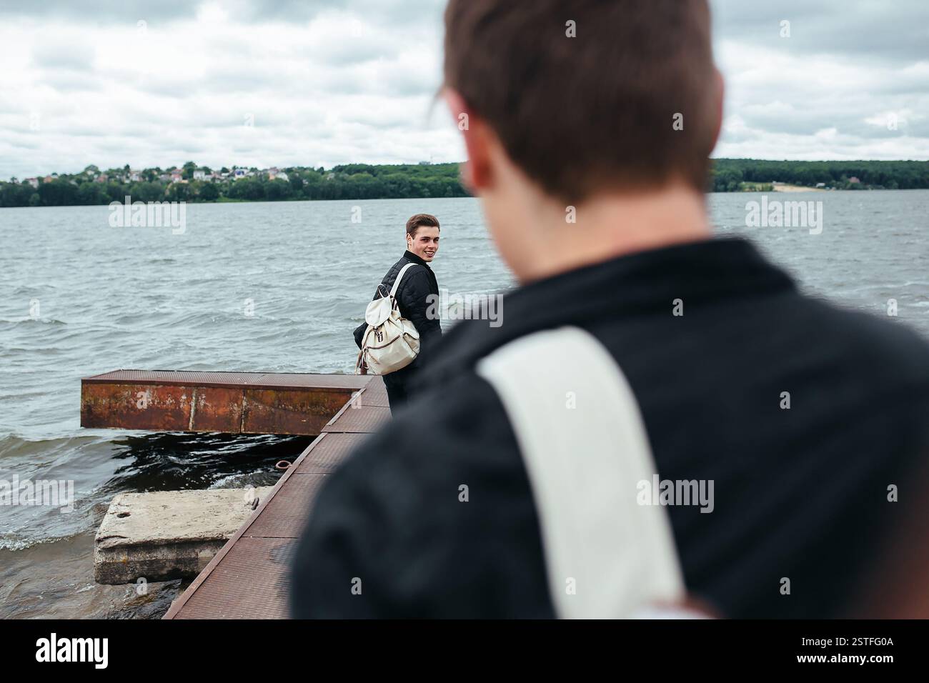 Young men on pier hi-res stock photography and images - Alamy