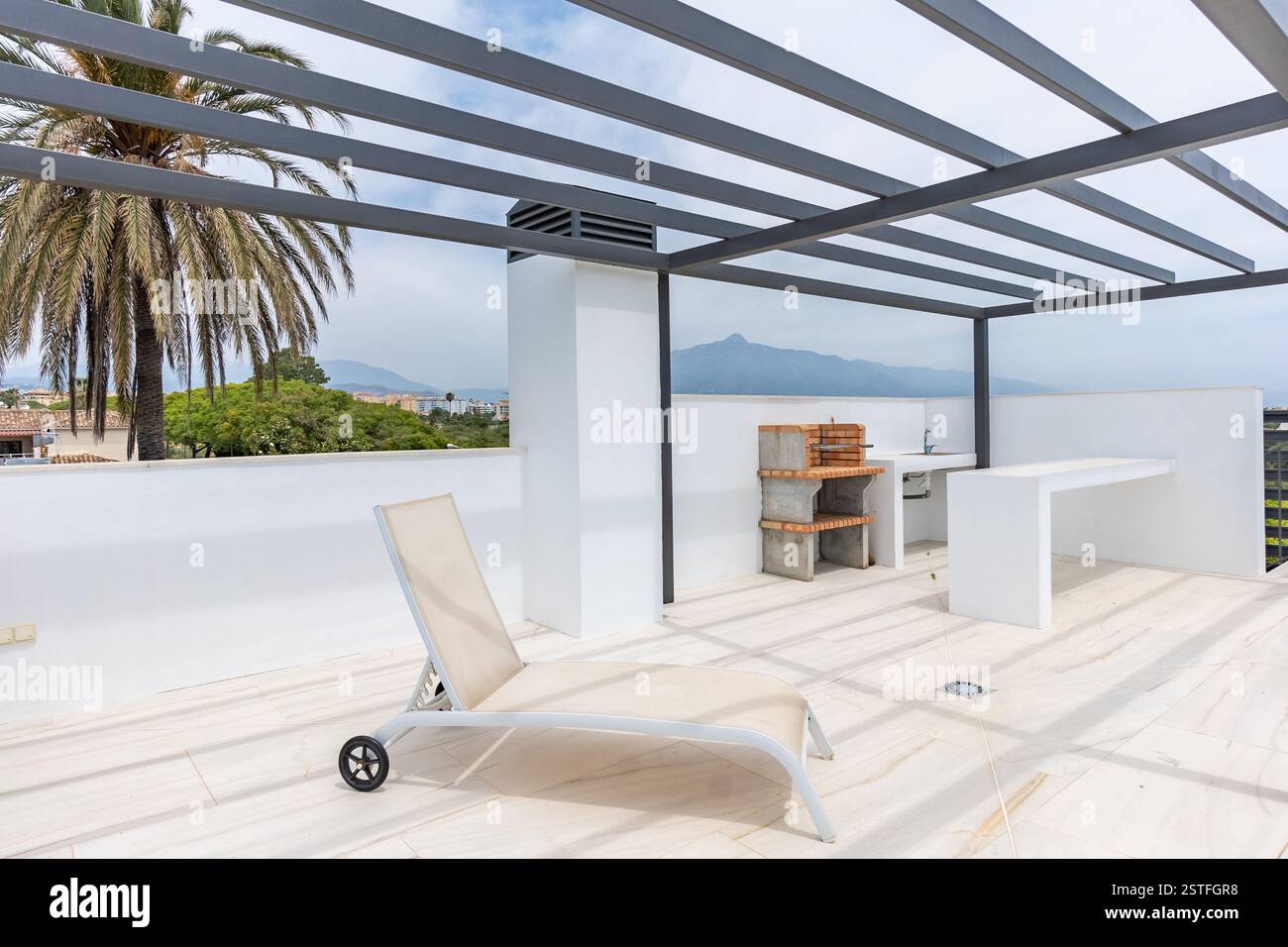 an image of a private rooftop terrace with sun lounger and barbecue ...