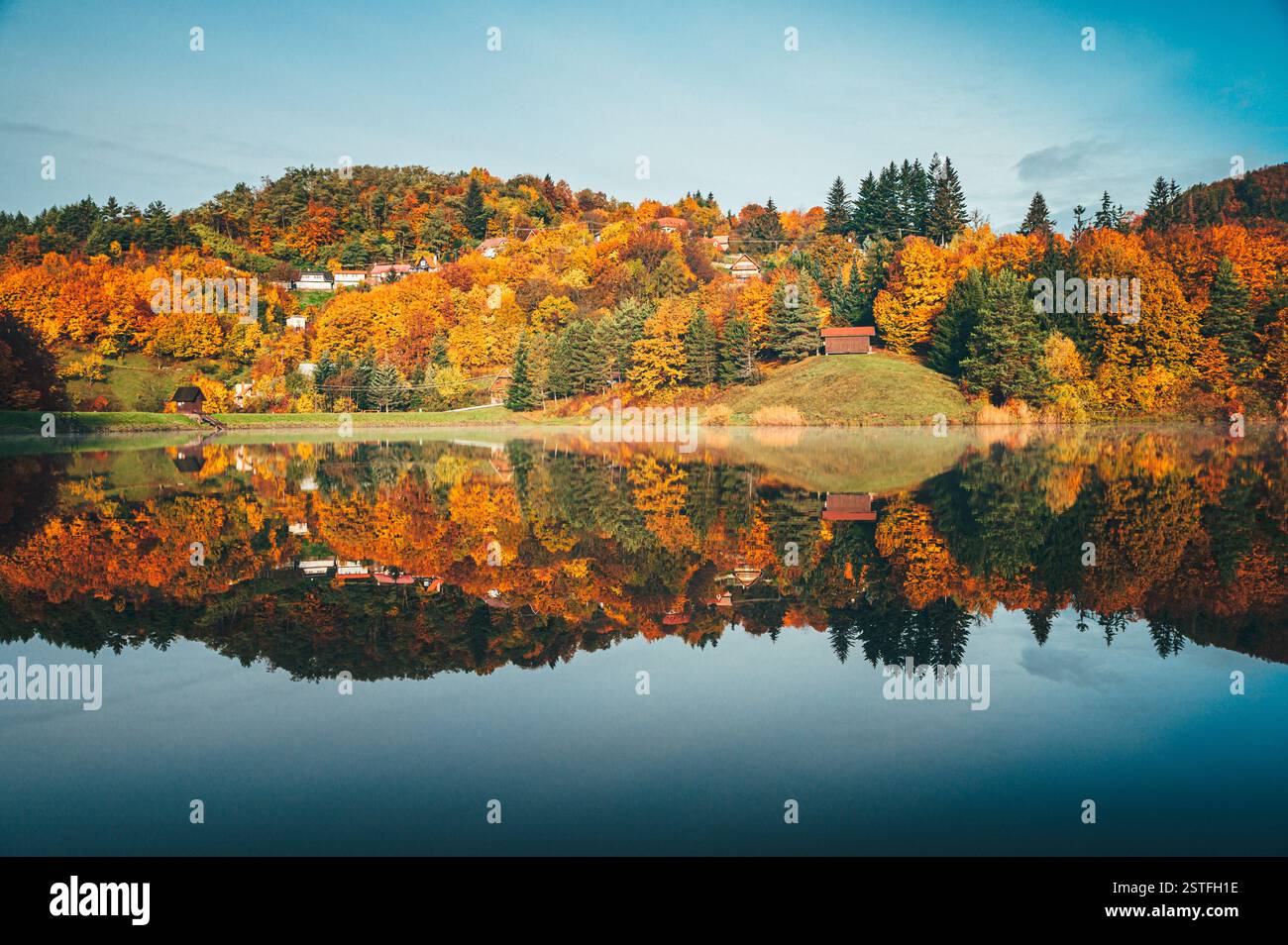 Vivid Autumn Hues Blending with the Misty Waters of a Quiet Lake Stock ...