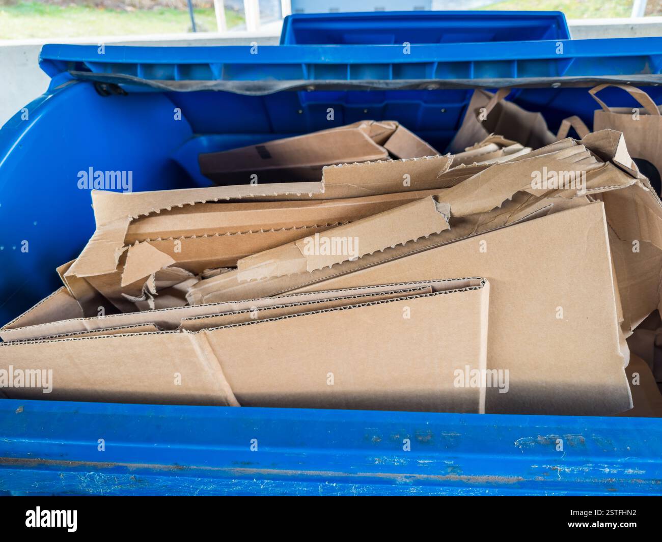 Recycling bin with discarded cardboard waste for sustainable waste ...