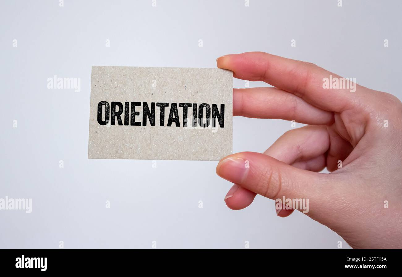 Orientation message written on a card in hand. Conceptual orientation ...