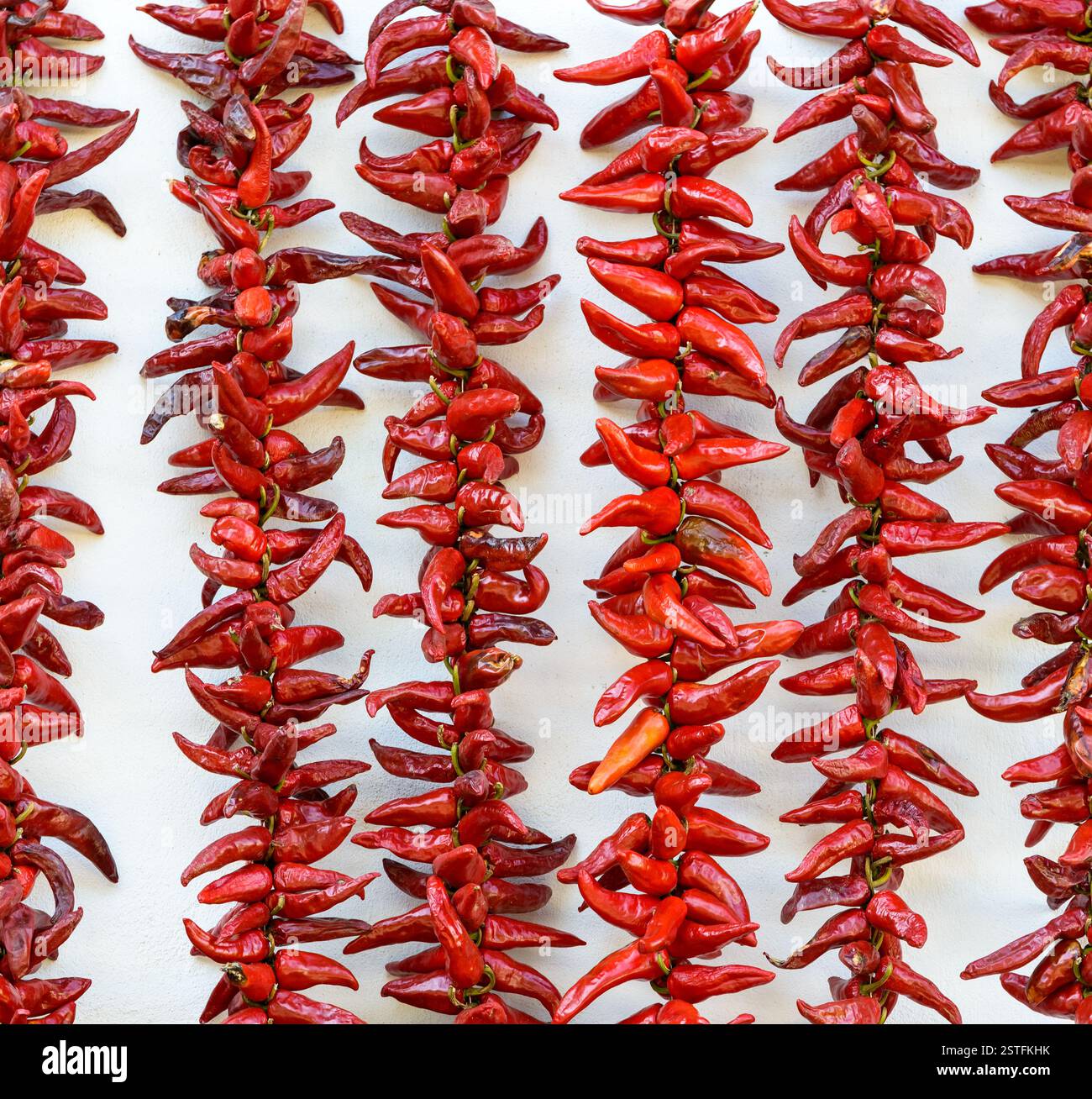 Strings of PDO Espelette chilli peppers drying Stock Photo - Alamy