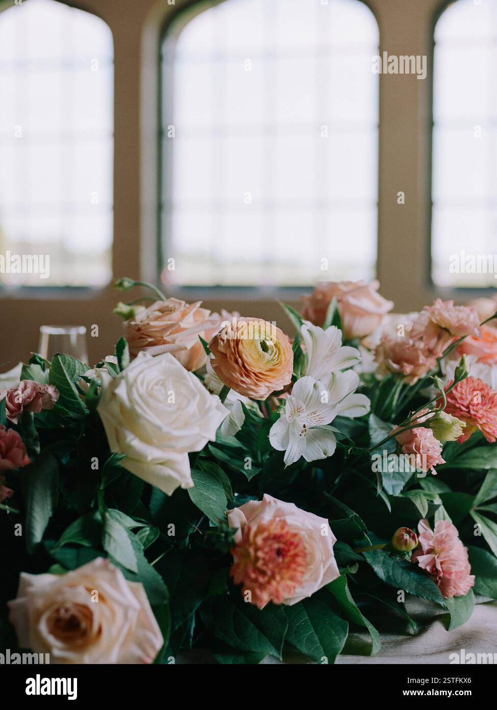 Colorful flowers create a vibrant centerpiece on a table inside a ...