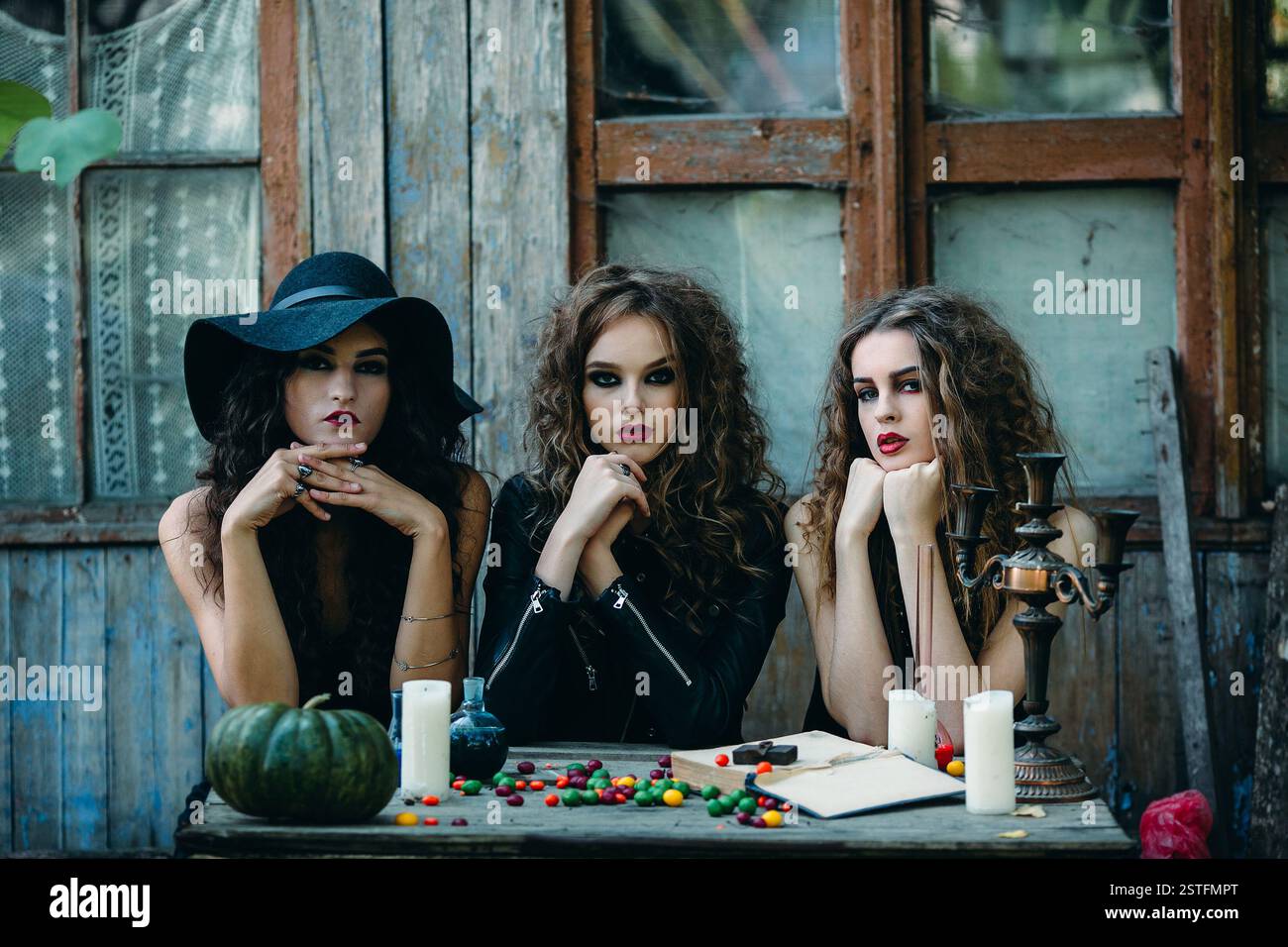 Three witches at the table Stock Photo - Alamy