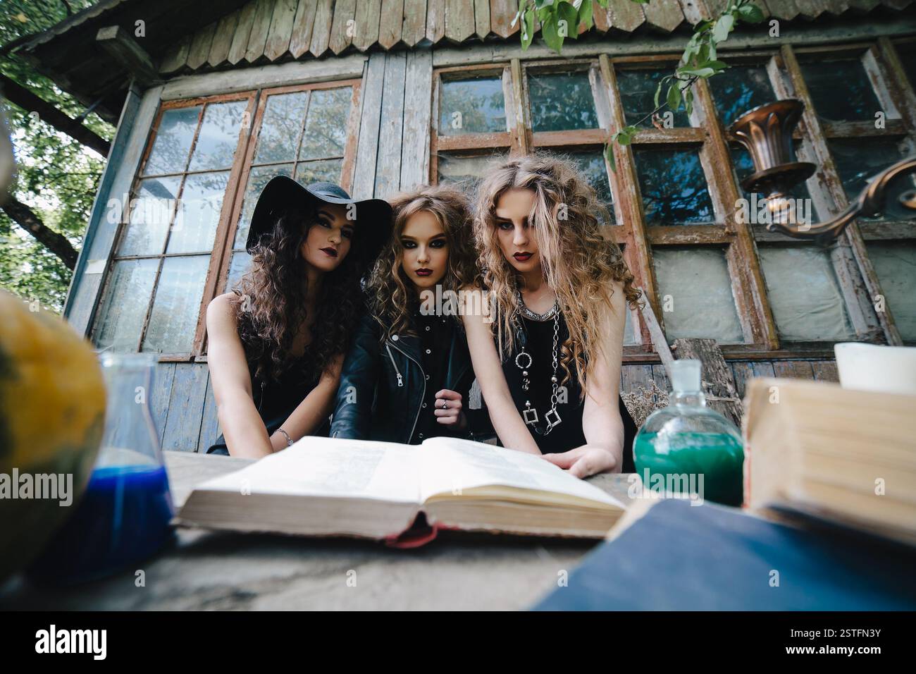 Three vintage witches perform magic ritual Stock Photo - Alamy