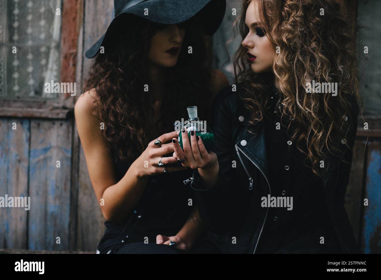 Two vintage witches perform magic ritual, with elixir in hand on the ...