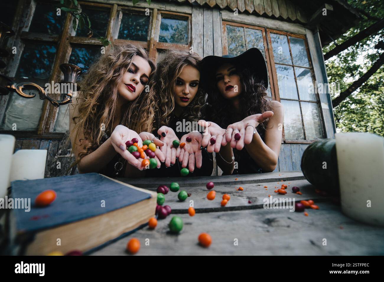 Three vintage witches perform magic ritual Stock Photo - Alamy