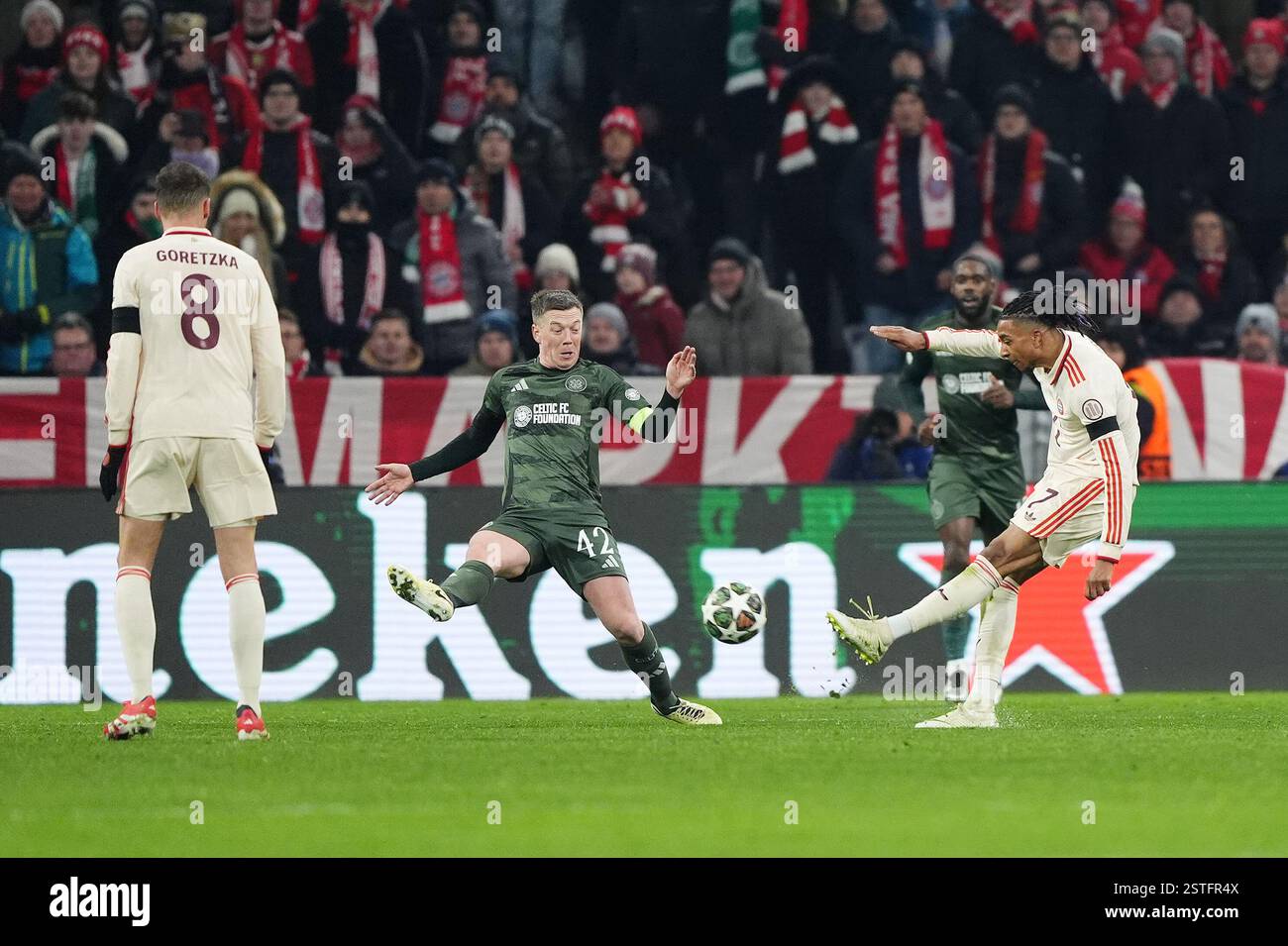 Bayern Munich's Michael Olise (right) attempts a shot on goal during ...