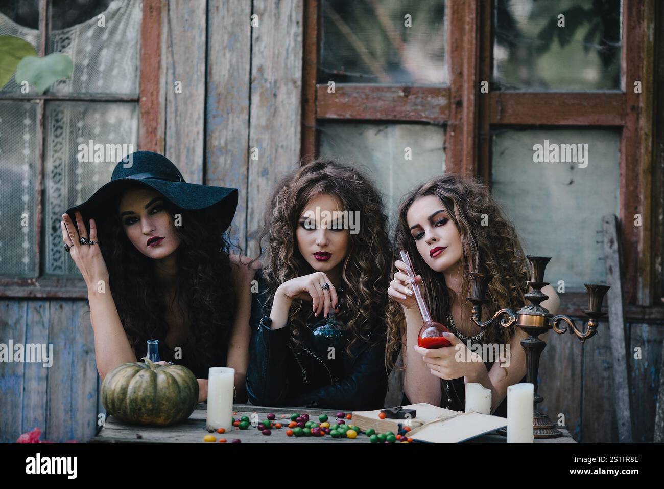 Three vintage witches perform magic ritual Stock Photo - Alamy