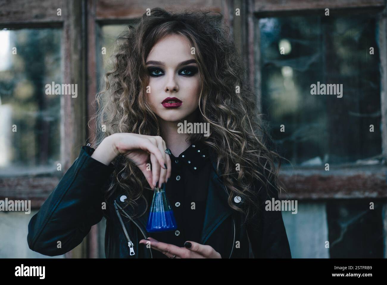 Vintage witch with elixir in hand Stock Photo - Alamy
