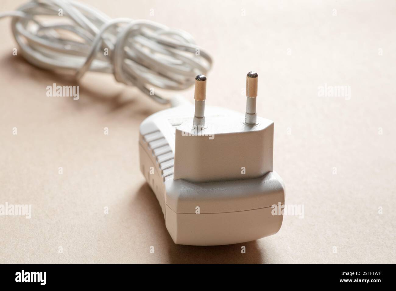 AC plug digital tablet adapter on brown paper background Stock Photo ...