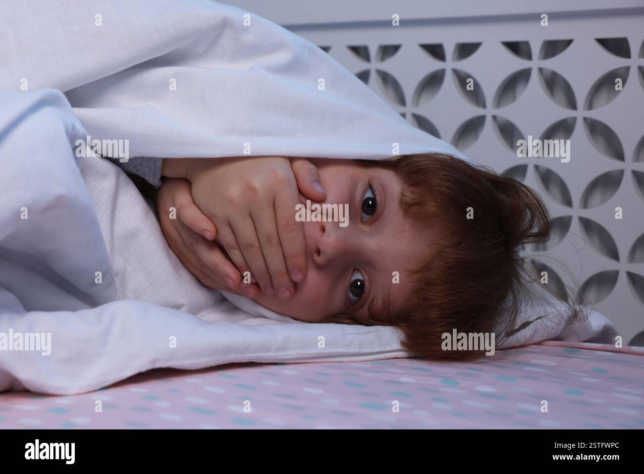 Afraid boy under blanket on bed at night Stock Photo - Alamy