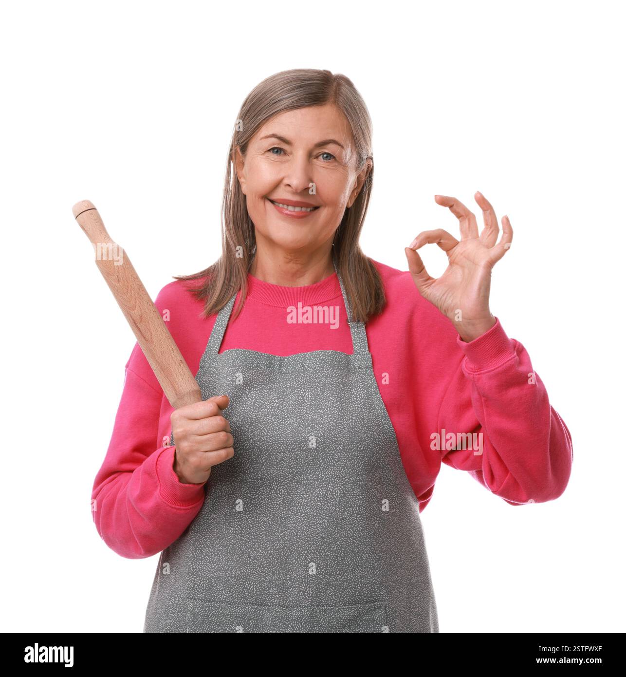 Happy woman with rolling pin showing ok gesture on white background ...