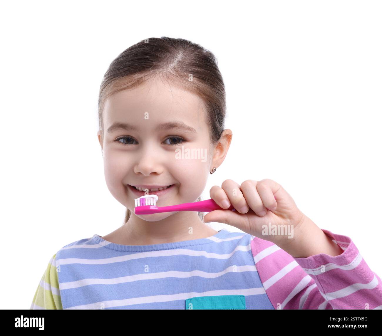 Cute girl brushing her teeth on white background Stock Photo - Alamy