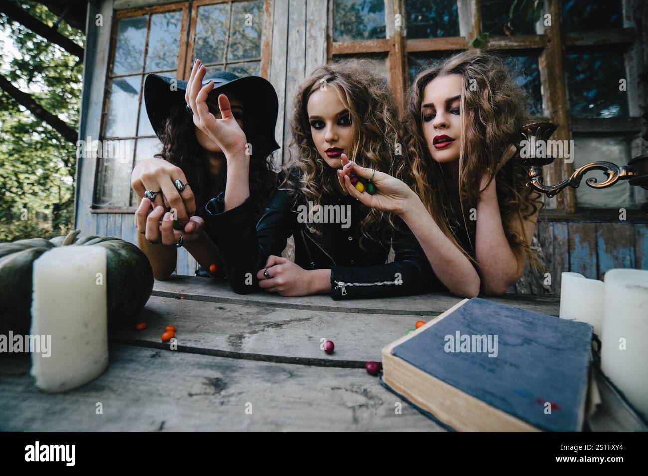 Three vintage witches perform magic ritual Stock Photo - Alamy