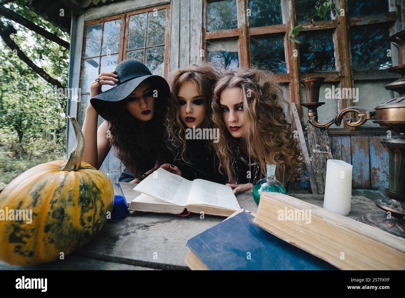 Three vintage witches perform magic ritual Stock Photo - Alamy