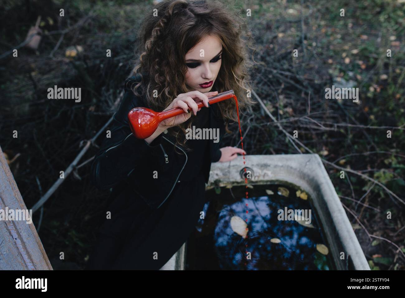 Vintage witch with elixir in hand Stock Photo - Alamy