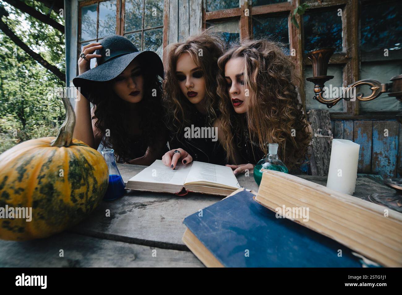 Three vintage witches perform magic ritual Stock Photo - Alamy