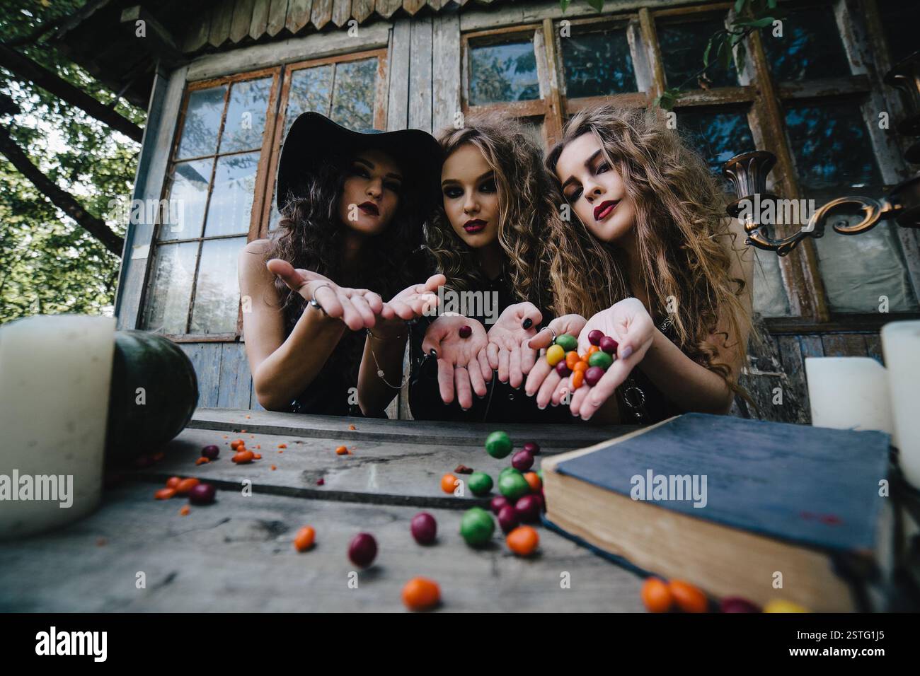 Three vintage witches perform magic ritual Stock Photo - Alamy