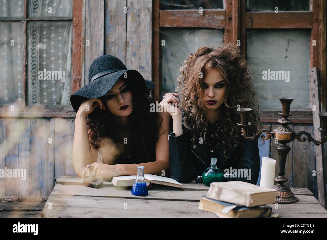 Two vintage witches perform magic ritual Stock Photo - Alamy