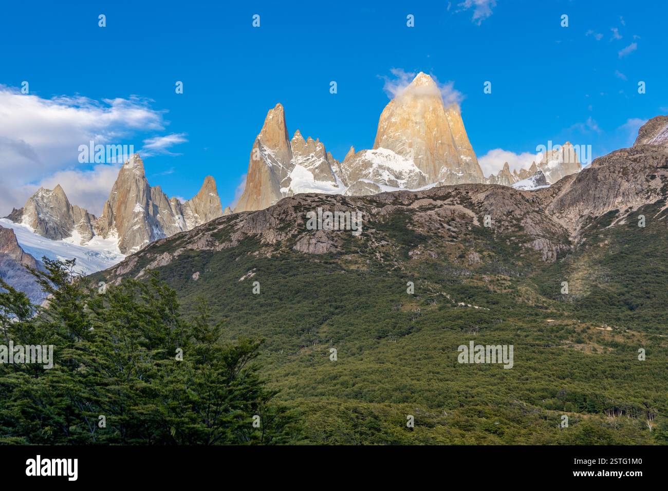 Fitz Roy sharp mountain peaks rise above a serene glacial lake ...