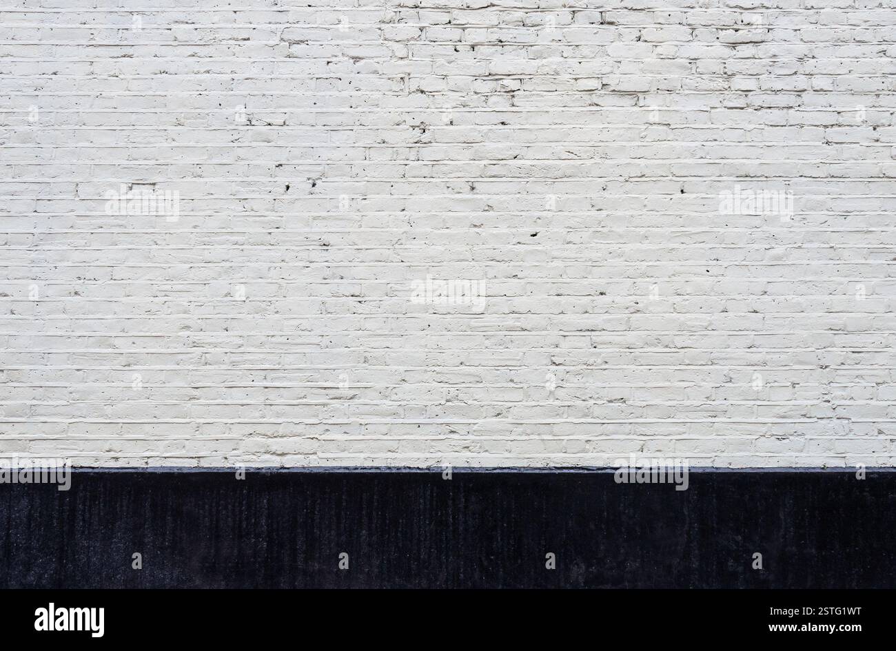 White brick wall and black skirting texture Stock Photo - Alamy